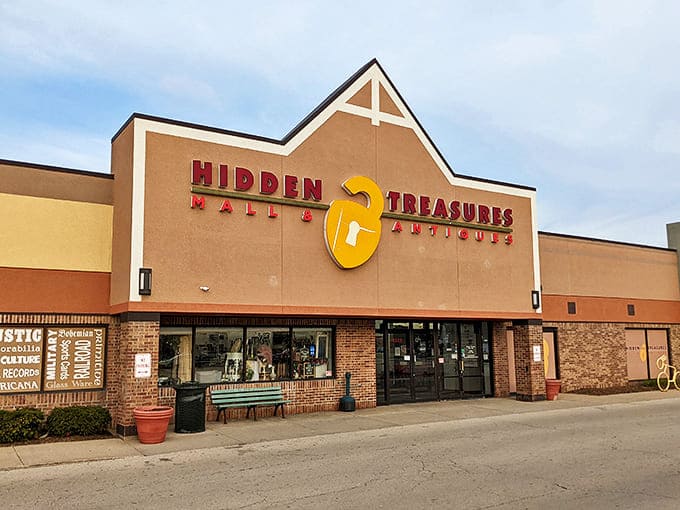 The welcoming facade of Hidden Treasures Mall & Antiques stands like a portal to the past, its bright yellow padlock logo promising adventures in nostalgia.
