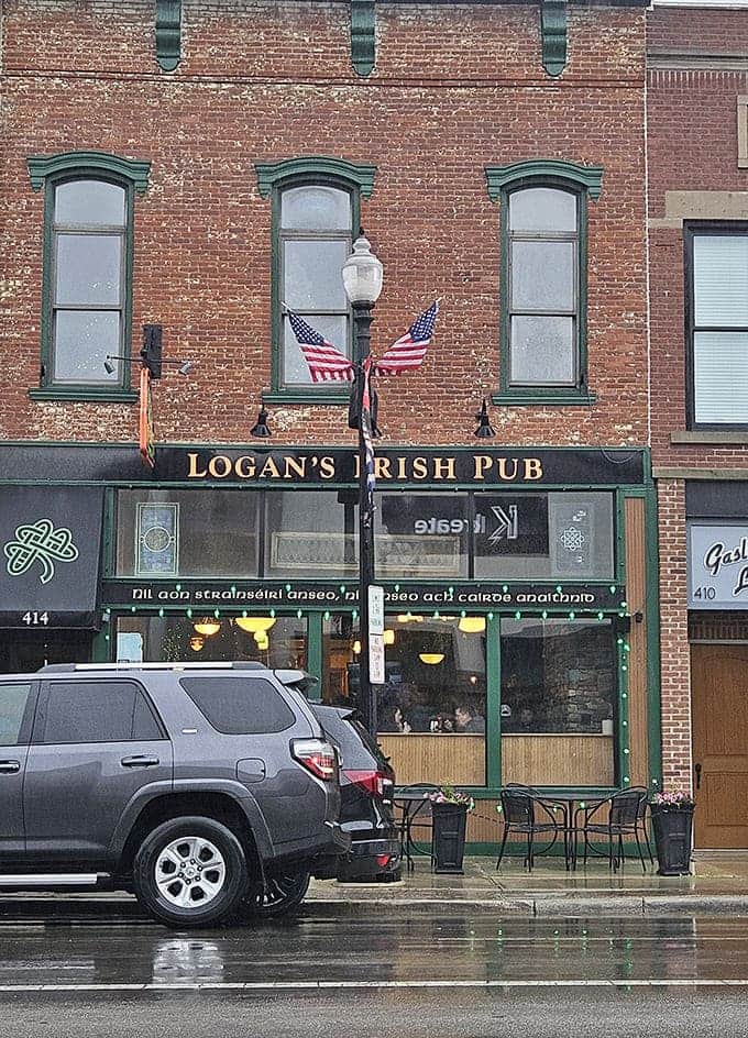 Logan's Irish Pub's inviting exterior beckons with its classic brick façade, emerald trim, and the promise of Irish hospitality waiting inside.