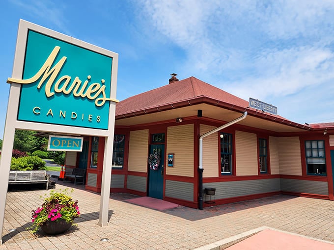 The iconic teal and cream exterior of Marie's Candies welcomes visitors like a sweet beacon in West Liberty, promising chocolate treasures within those cheerful red-trimmed walls.
