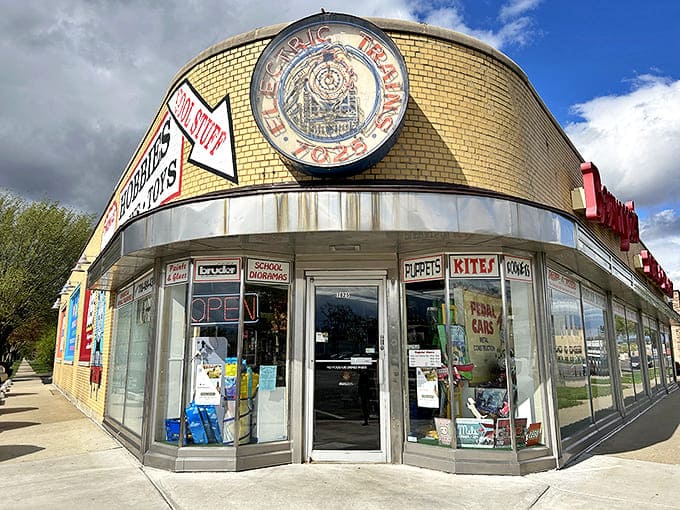 The iconic yellow brick facade of Berwyn's Toy & Trains stands as a beacon of nostalgia on the street, promising wonders within.