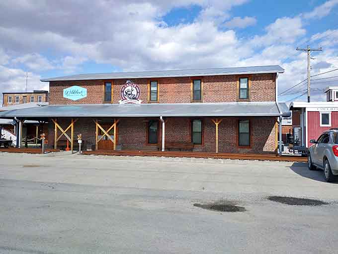The brick fa&ccedil;ade of Wildflour Bakery & Candy Co. promises sweet adventures within, while the covered porch invites weary travelers to pause.