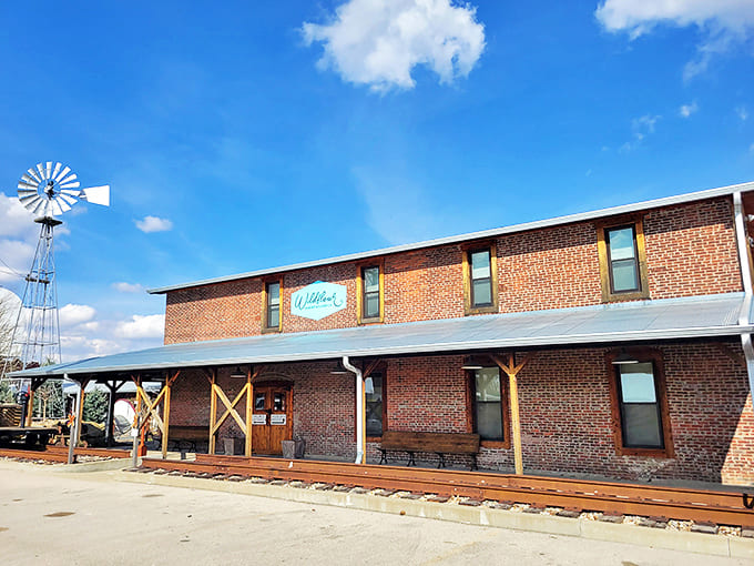 Brick and charm collide at Wildflour Bakery, where that vintage windmill stands guard like a sweet sentinel over sugar paradise.