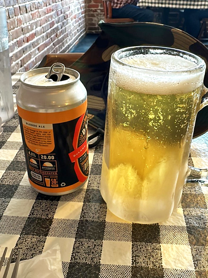 A frosty mug of beer alongside the can &ndash; because presentation matters even in the most unpretentious settings, especially on a warm Florida afternoon.
