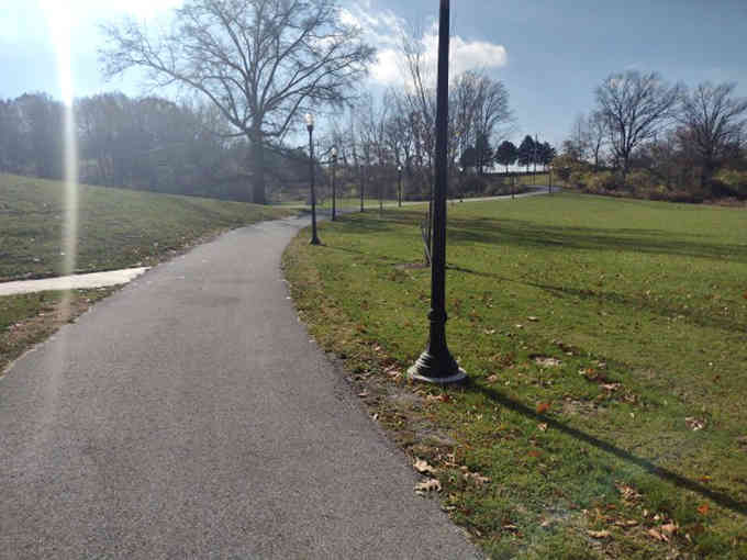 The winding path stretches ahead like nature's welcome mat, promising adventures just around the bend.