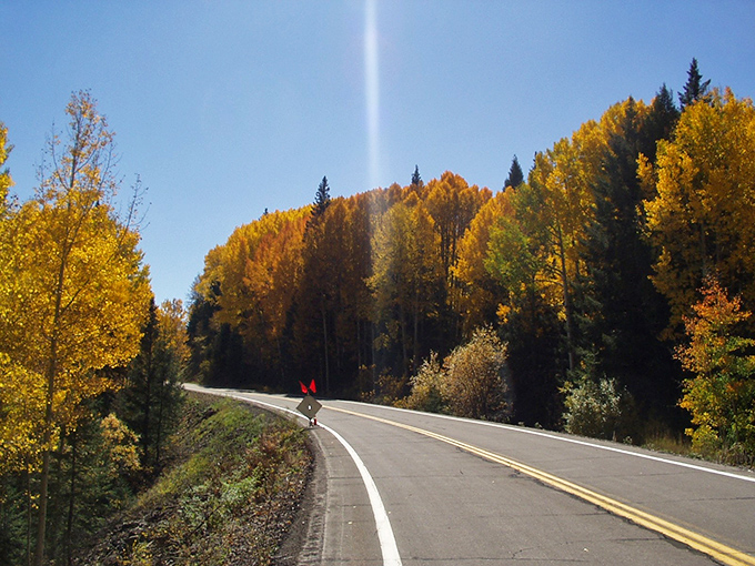 Nature's annual fashion show transforms mountain corridors into golden galleries, where aspen trees flaunt their autumn finery.