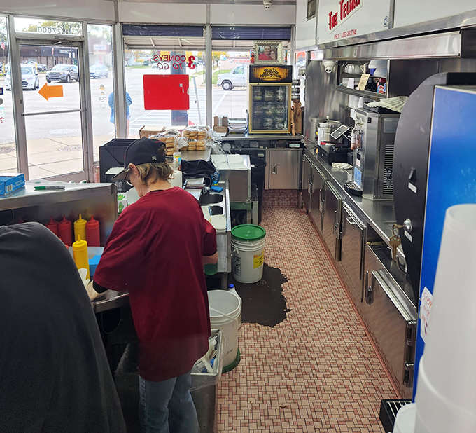 The narrow galley kitchen where magic happens &ndash; tight quarters ensuring no movement is wasted in the pursuit of perfect diner fare.