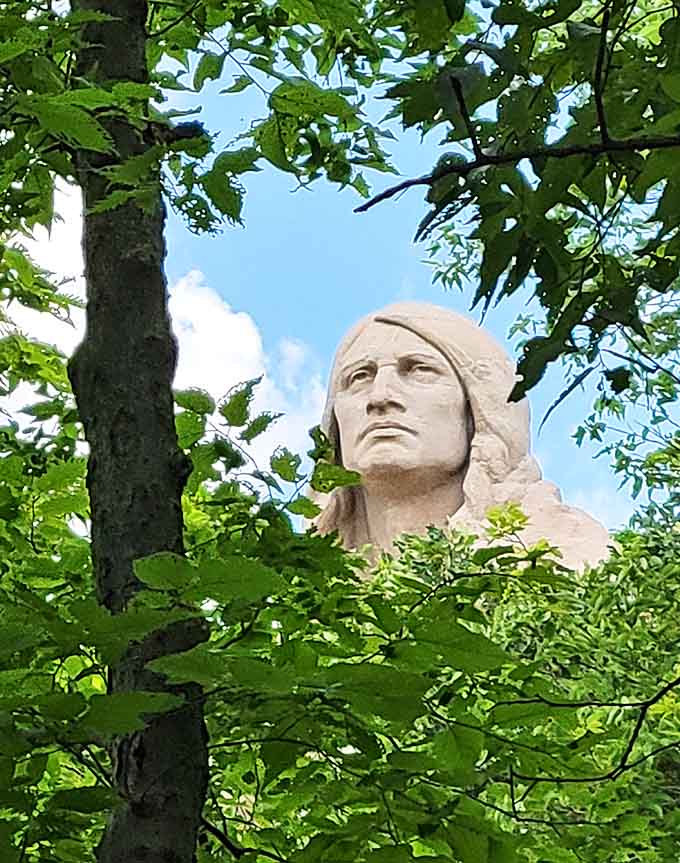 The face gazes eternally eastward, features weathered by time yet still conveying a sense of quiet strength and dignity.