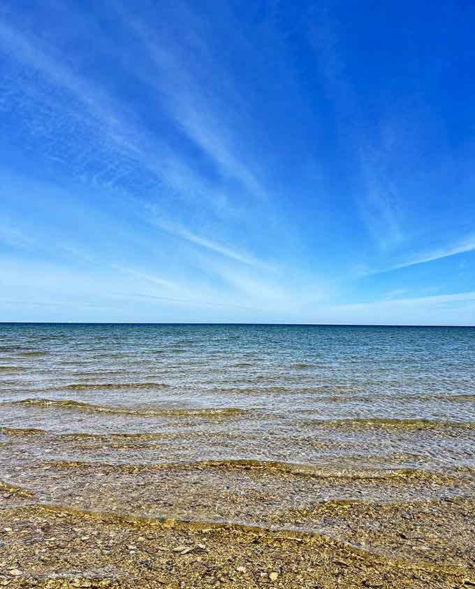 The hypnotic meeting of sky and water creates a horizon so perfect it looks digitally enhanced, yet it's just another Tuesday in Michigan.