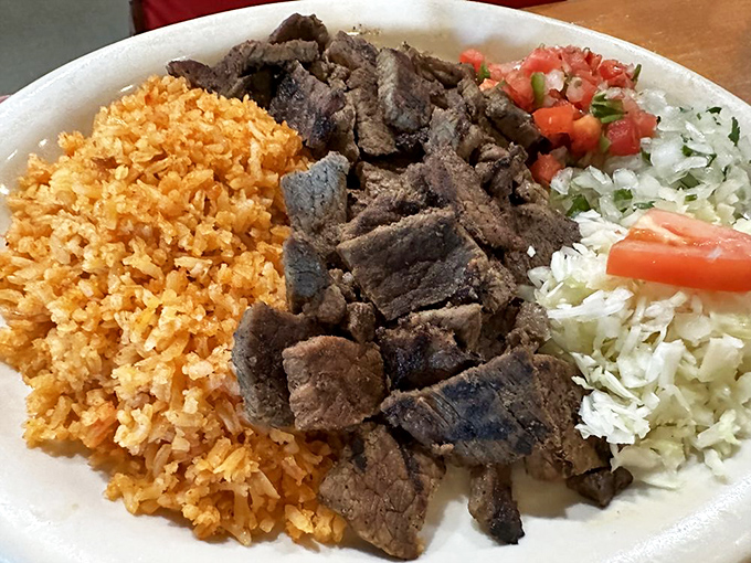 A carnivore's dream featuring perfectly grilled steak, fluffy rice, and fresh pico de gallo – simple food executed with expert precision.
