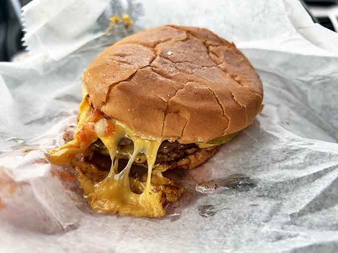 Cheese that stretches for days! This burger demonstrates why Ray's has a devoted following &ndash; melty American cheese cascading over a hand-formed patty.