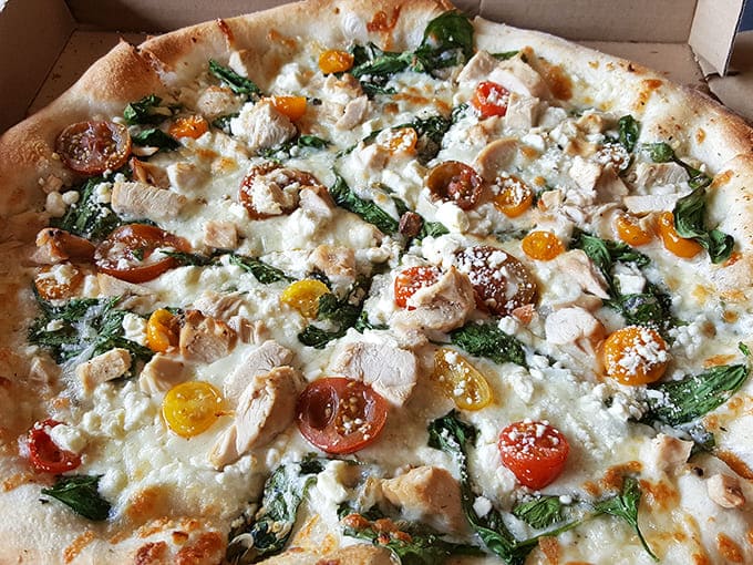 Chicken, spinach, and multicolored tomatoes create a pizza so beautiful you almost don't want to eat it &ndash; almost.