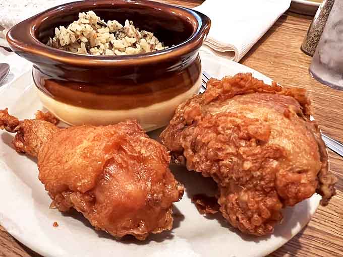 Chicken: Golden-brown perfection &ndash; crispy outside, juicy inside &ndash; served alongside wild rice in a rustic crock that keeps everything piping hot.