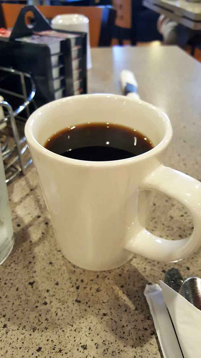 Hot coffee flows freely here, providing the essential fuel that makes morning conversations and good meals even better.