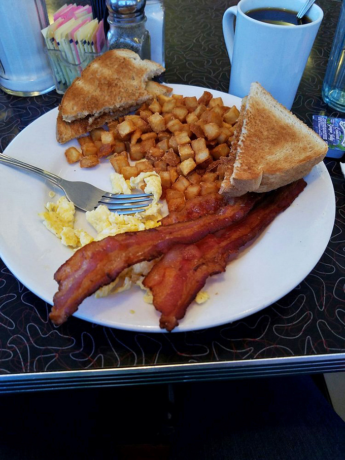 The classic American breakfast in its natural habitat &ndash; eggs, bacon, toast, and potatoes arranged like old friends catching up after too long apart.