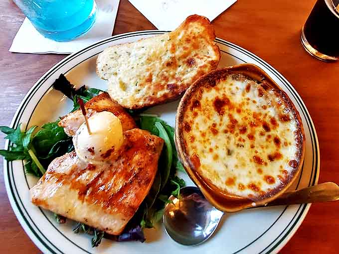Beneath that glorious canopy of bubbling cheese lies a rich, savory broth that's been simmering its way to perfection for hours.