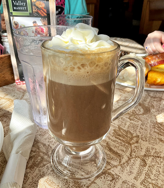 Hot chocolate that doesn't just warm your hands but hugs your soul – topped with a cloud of whipped cream.