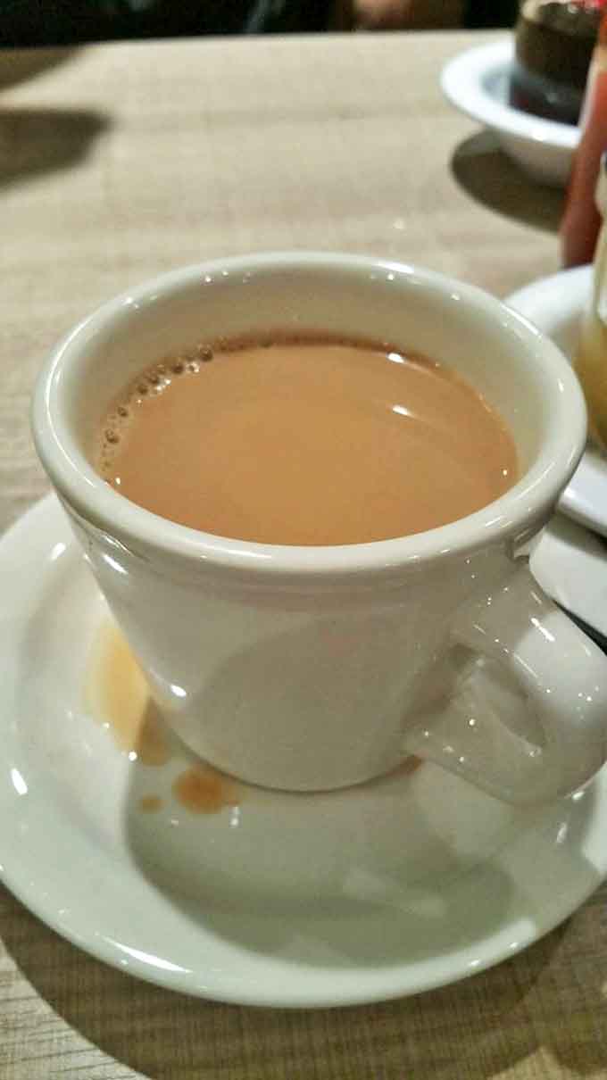 Coffee served in proper ceramic cups stays hot and tastes like coffee should, rich and smooth without needing fancy additions.