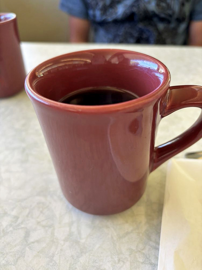 Coffee served in the only vessel that truly matters – a sturdy diner mug that keeps refills coming faster than your stories.