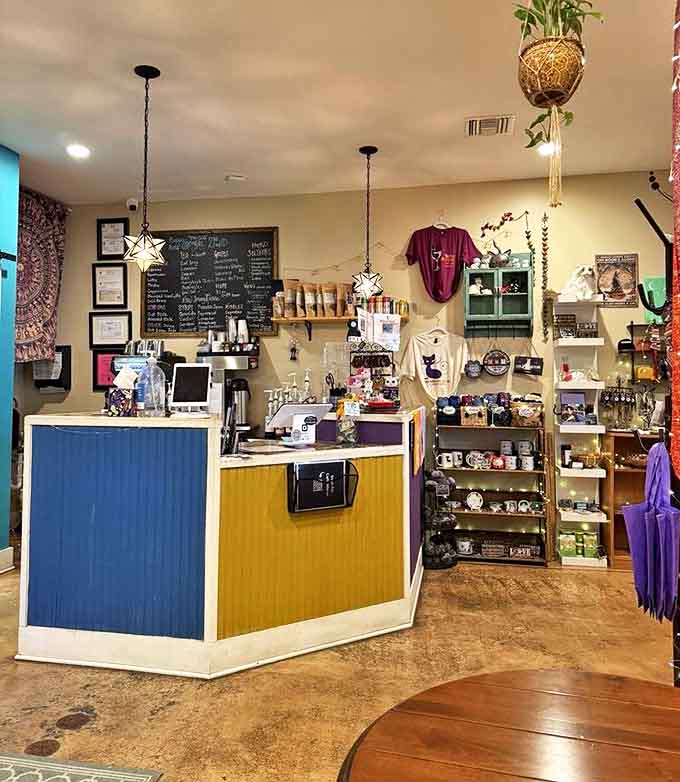 The colorful counter area blends playful design with functionality, where baristas craft beverages while cats rule the adjacent kingdom.