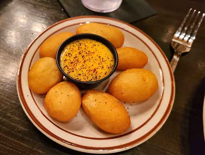 These golden popovers with honey butter are basically edible clouds, the kind of bread basket that derails all pre-meal diet plans.