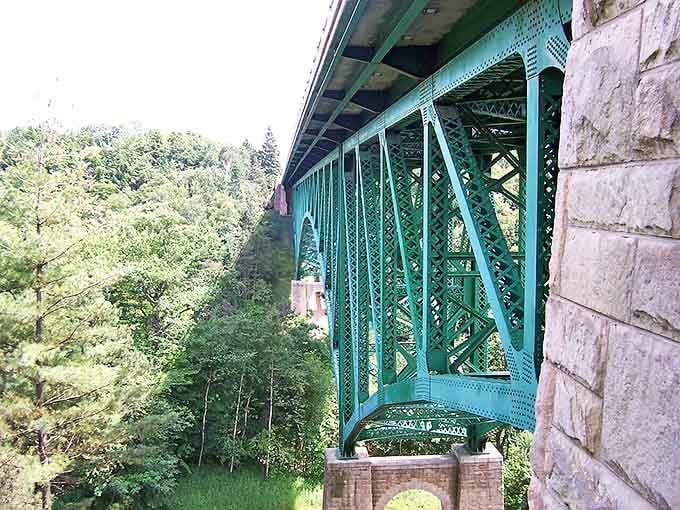 Cut River Bridge spans a verdant valley with architectural grace, offering both passage and pause-worthy views for appreciative travelers.