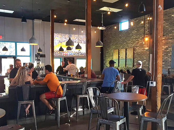Cornhole boards await challengers while patrons debate the merits of IPAs versus lagers between competitive tosses.