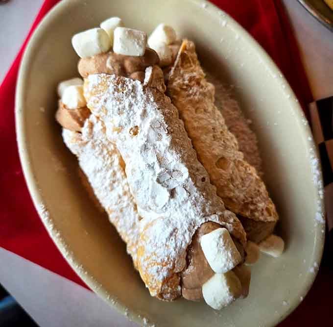 Cannoli shells stuffed with sweet ricotta cream, because ending on a high note is always the right choice.