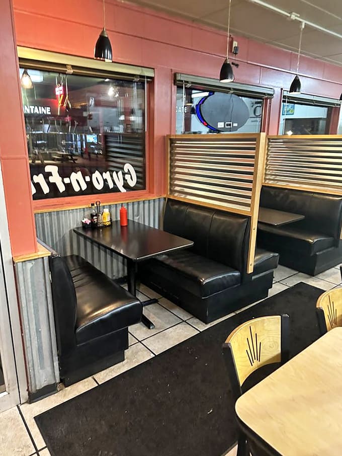 Cozy booths line the walls, offering perfect spots for families and friends to gather over generous plates of comfort food.