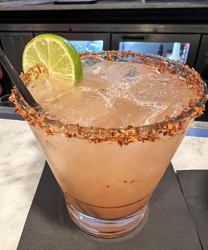 A coconut-rimmed margarita that looks like Florida in a glass – tropical, refreshing, and just waiting to complement those seafood flavors.