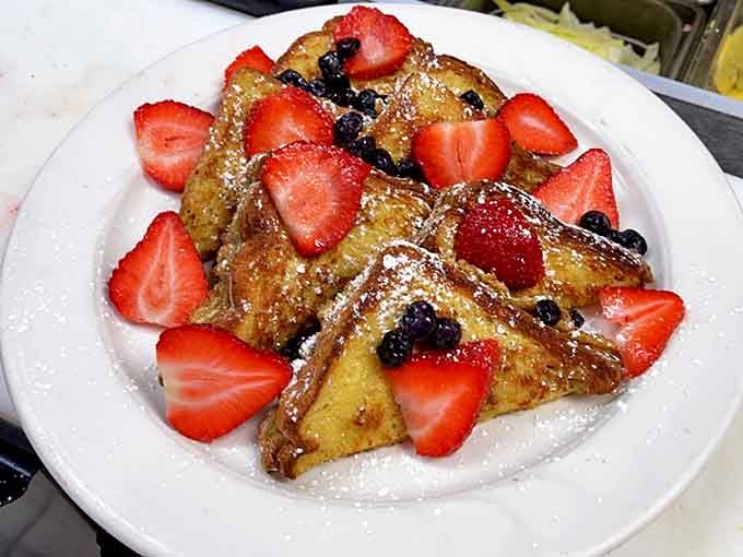 French toast that deserves its own fan club &ndash; golden-brown perfection adorned with fresh berries and a dusting of powdered sugar.