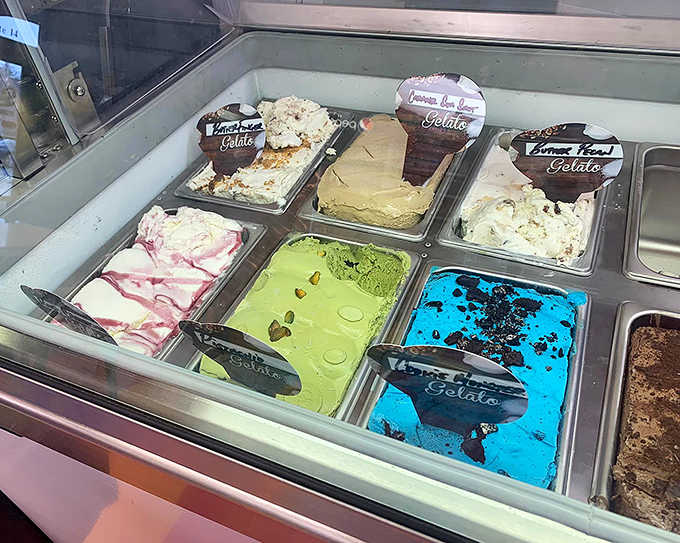 The gelato case offers a rainbow of frozen treasures &ndash; each scoop promising a cool, creamy contrast to those warm donuts.