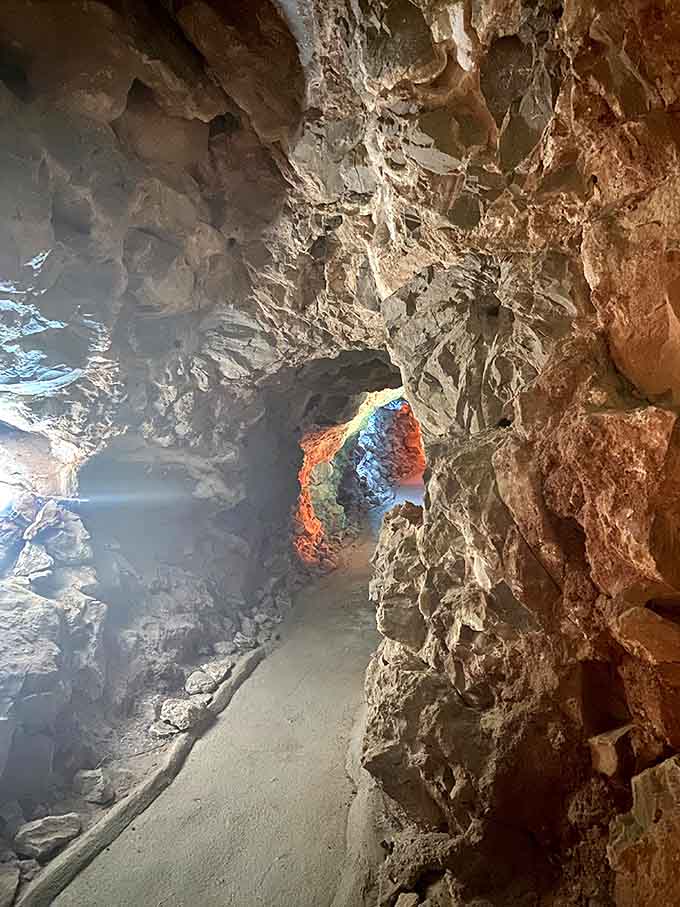 The illuminated pathway winds through chambers that seem to go on forever, each turn revealing new geological wonders.