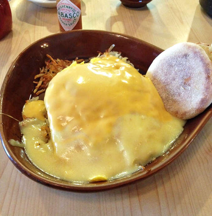 Grandma's Skillet drowning in cheese and hollandaise&mdash;a breakfast so decadent it requires a nap afterward and zero regrets.