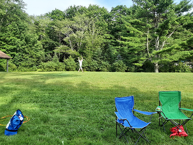 Open green spaces provide room for frisbee, catch, or simply lounging in portable chairs. The simple pleasures of outdoor living.