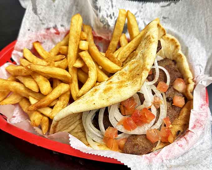 The gyro sandwich wraps seasoned meat and fresh vegetables in warm pita, creating handheld perfection that's worth the inevitable mess.