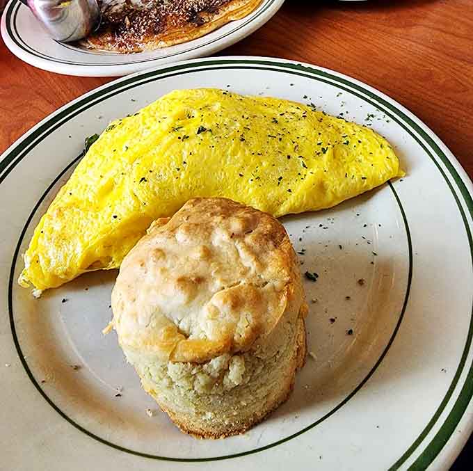 A perfectly folded omelet with a fluffy biscuit proves they take their egg game seriously here.