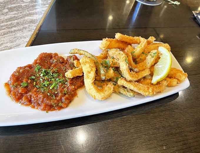 Crispy calamari arrives golden and tender, paired with zesty marinara that makes this appetizer dangerously shareable.