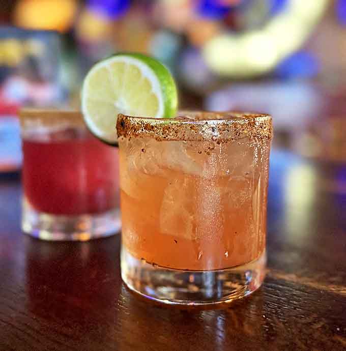 That cocktail with its sugared rim is basically a vacation in a glass, minus the sunburn and airport security lines.