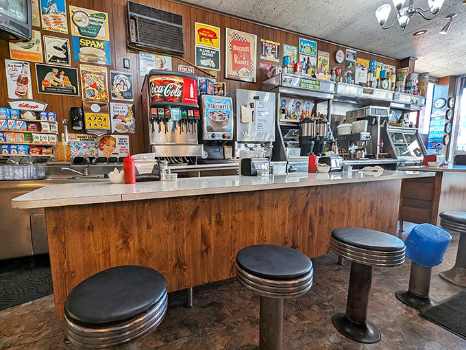 The counter where regulars perch like birds on a wire, watching the morning unfold over endless coffee refills and friendly banter.
