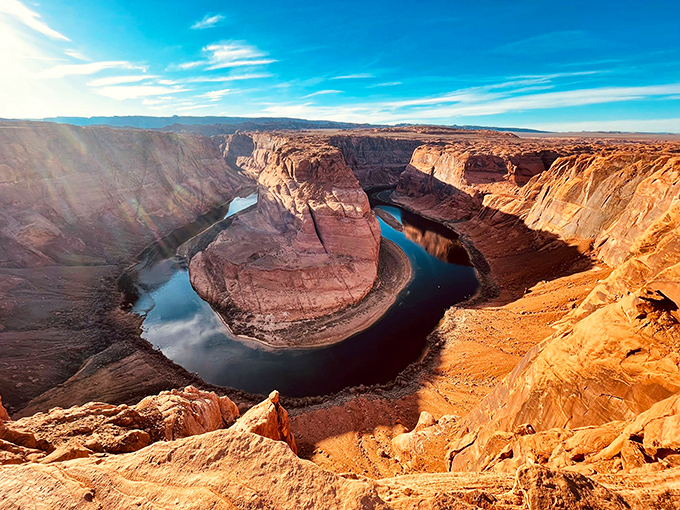 Horseshoe Bend showcases the Colorado River's artistic side, carving a perfect curve through ancient stone like nature's own signature.