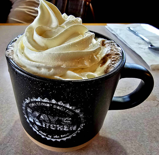 Kay's hot chocolate arrives crowned with a mountain of whipped cream in their signature mug&mdash;the perfect companion for Minnesota's chilly days.