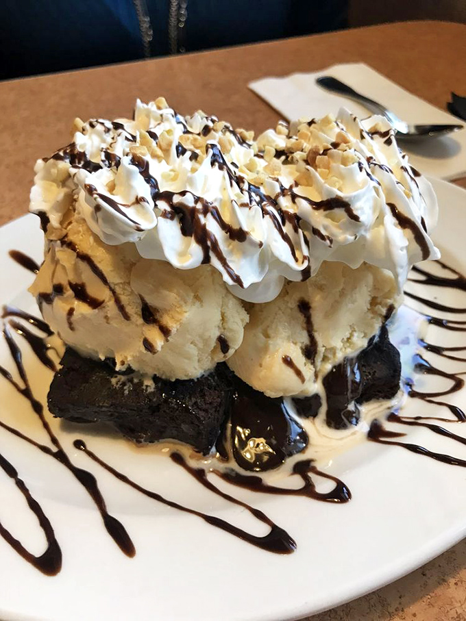 This brownie sundae isn't just dessert &ndash; it's an architectural marvel of chocolate, ice cream, and whipped cream that makes adults giggle.