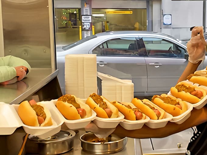 Assembly line perfection that would make Henry Ford proud &ndash; these Coney Dogs await their final toppings before bringing joy to hungry Detroiters.