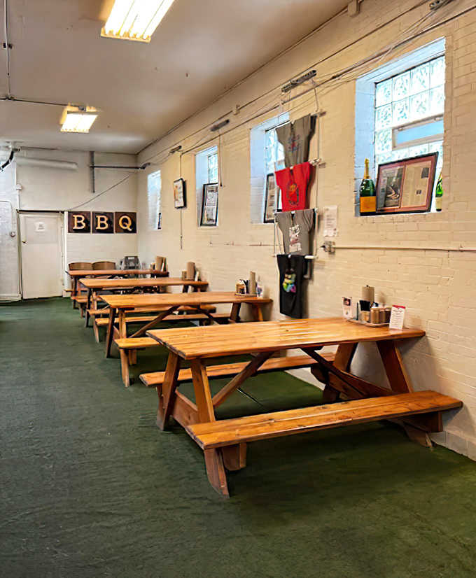 No-frills dining at its finest! These picnic tables aren't trying to impress &ndash; they're just sturdy platforms for the meat feast about to unfold.