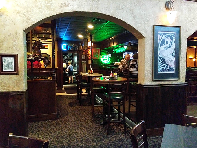 The warm wood paneling and arched doorways guide guests between dining areas, each with its own character but sharing Kelly's signature charm.