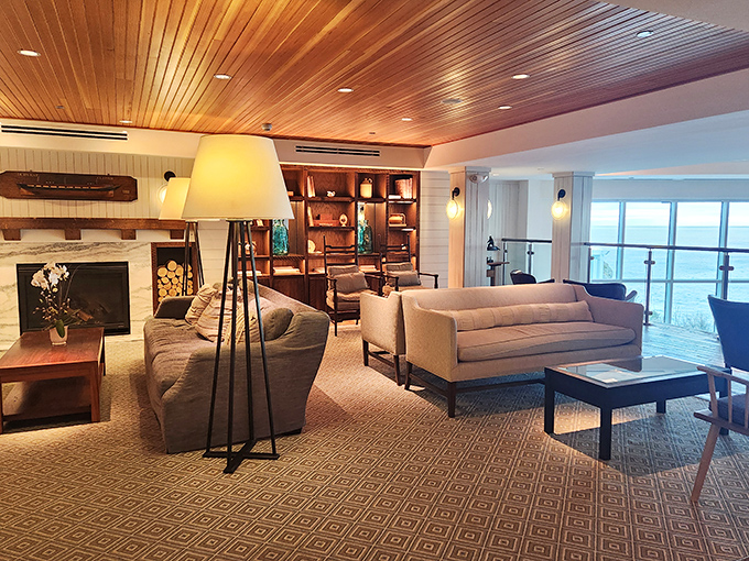 Warm wooden ceilings and coastal-inspired furnishings create a cozy lounge where ocean views and comfort perfectly blend together.