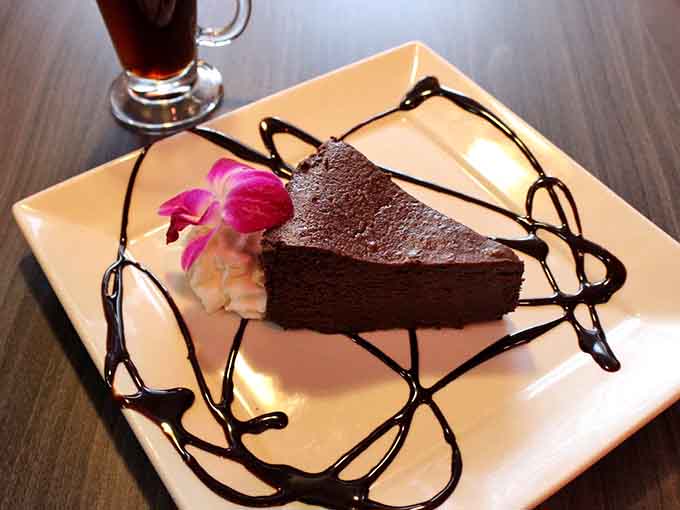 The flourless chocolate torte is a chocolate lover's dream, rich and decadent with artistic chocolate drizzle.