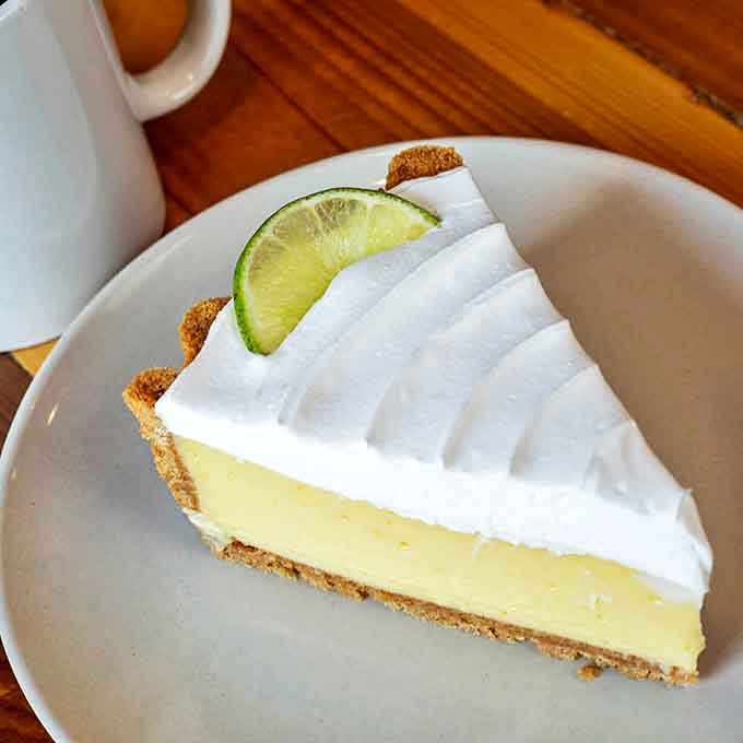 The perfect finale &ndash; bright, tangy key lime filling atop a buttery graham cracker crust, crowned with a cloud of whipped cream.