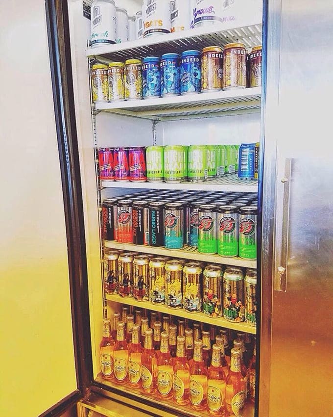 The beer fridge – where local craft brews stand at attention, waiting for their chance to wash down smoky goodness with hoppy harmony.