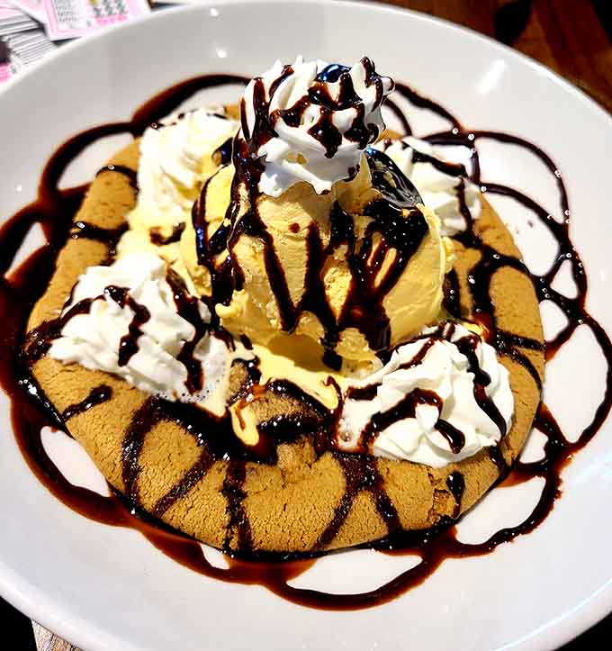 The chocolate chip cookie sundae arrives like a warm hug covered in whipped cream and chocolate.